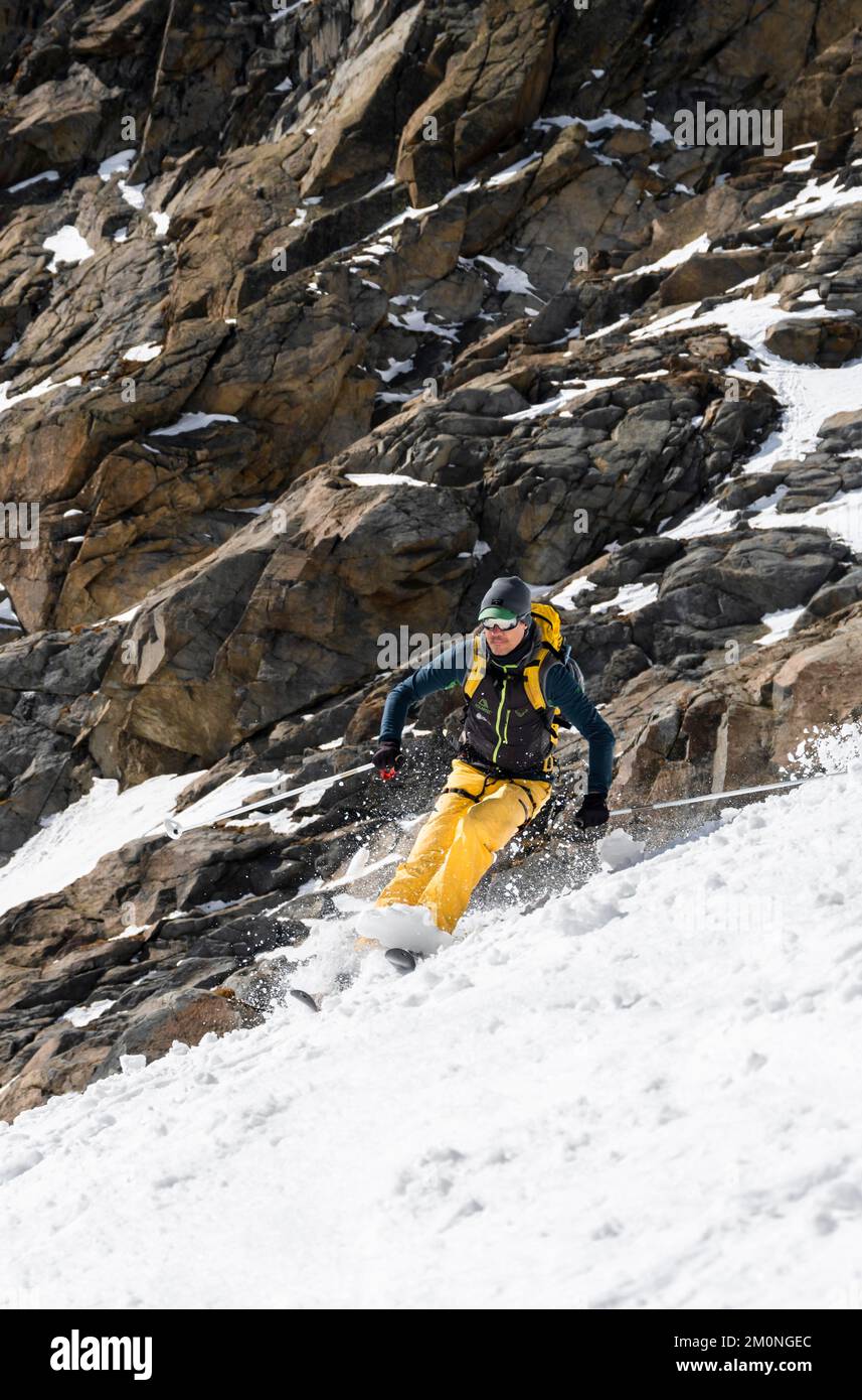 Ski tourers descending a steep slope, Stubai Alps, Tyrol, Austria ...