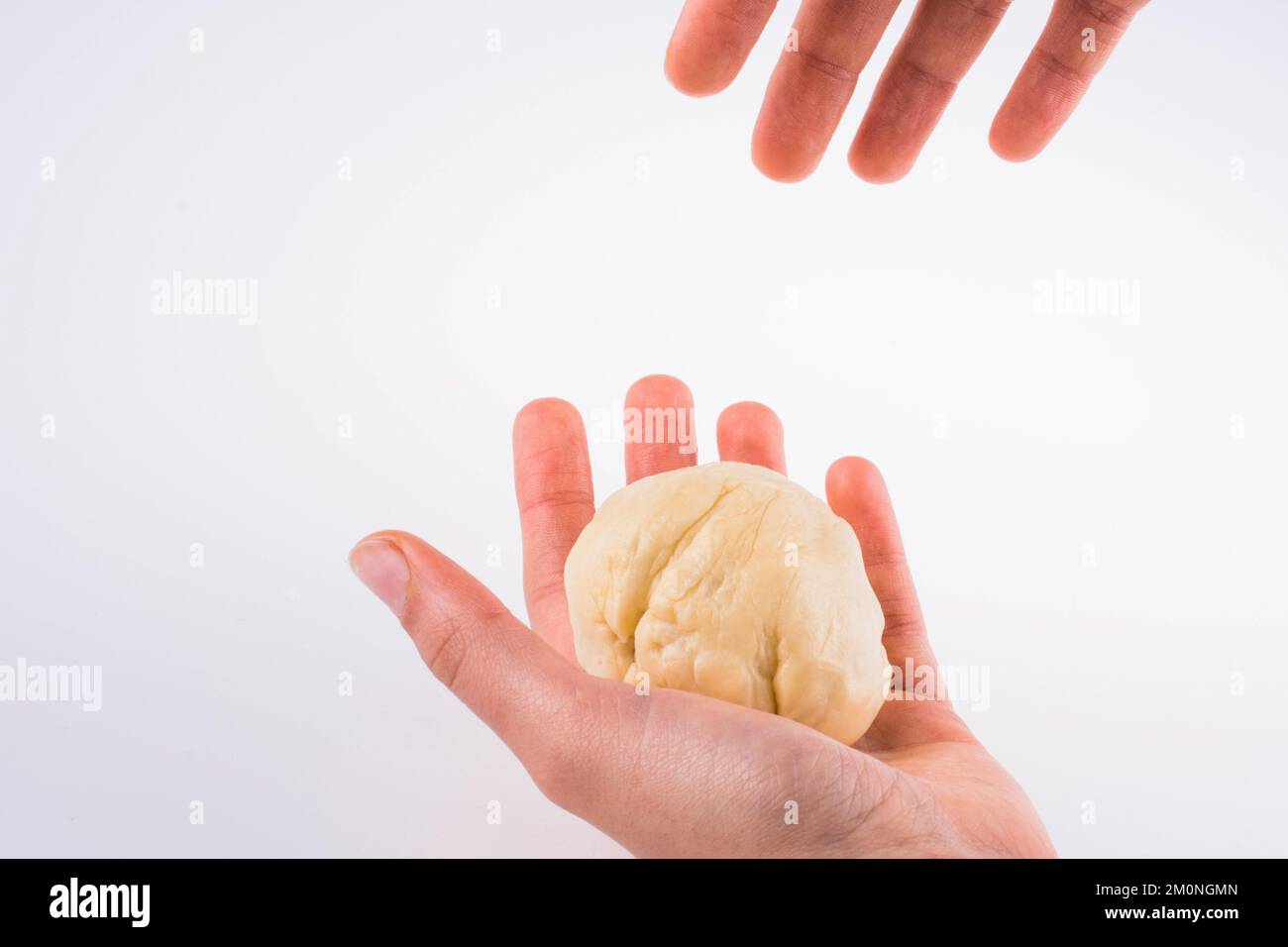 Hand holding paste on a white background Stock Photo - Alamy
