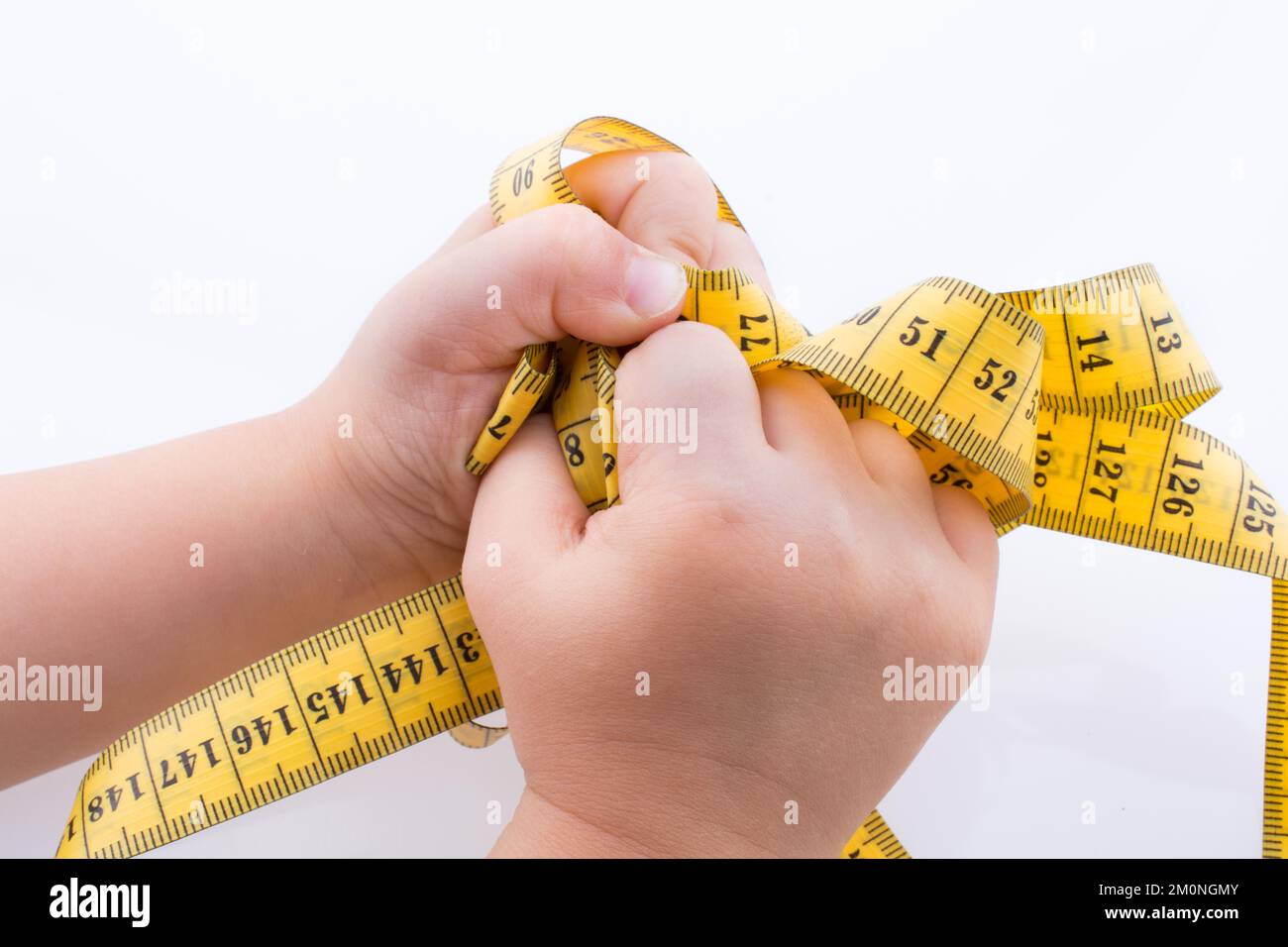 Hand holding a yellow color measuring tape on a white background Stock ...