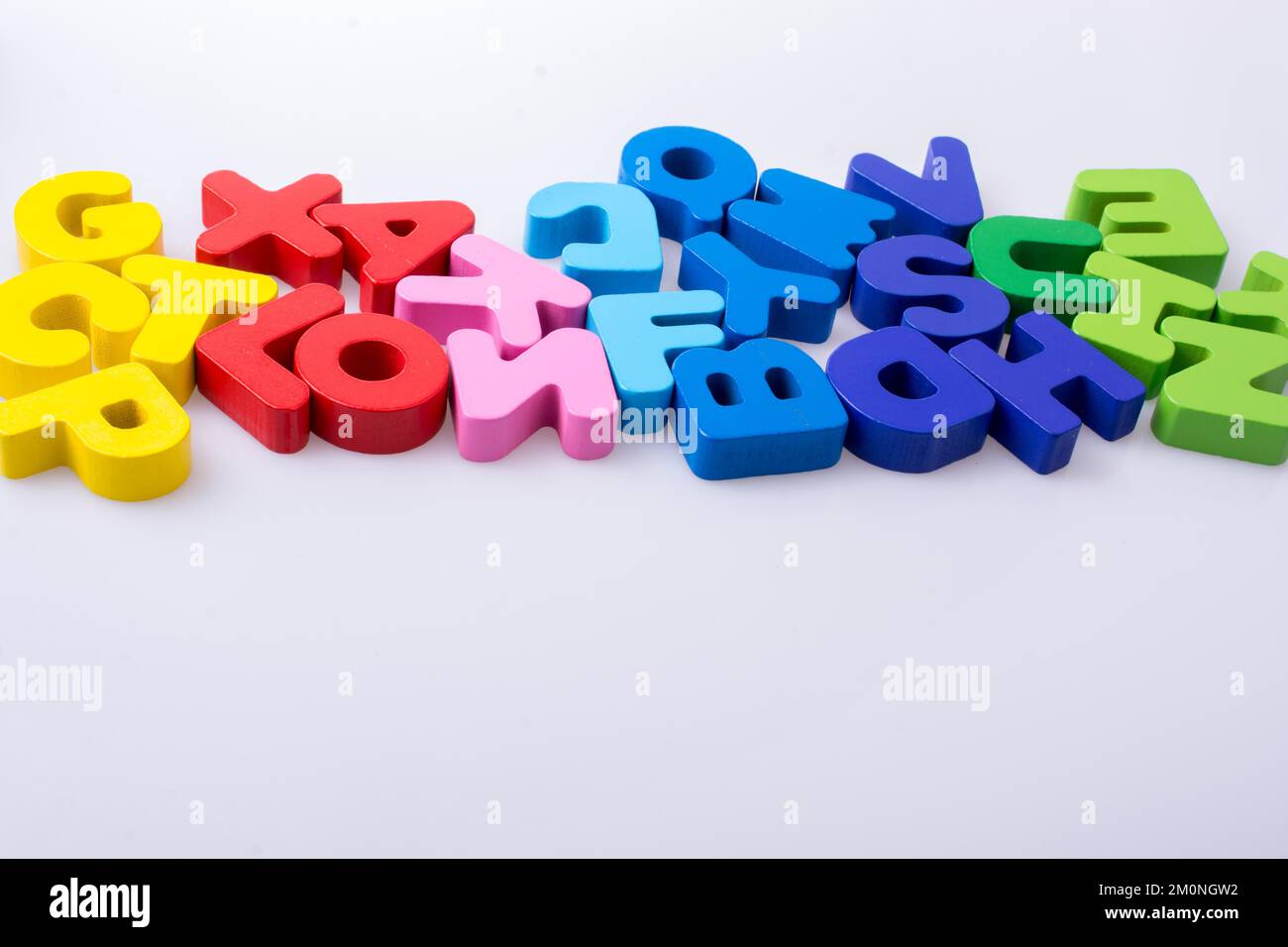 Colorful alphabet letter blocks scattered randomly on white background ...