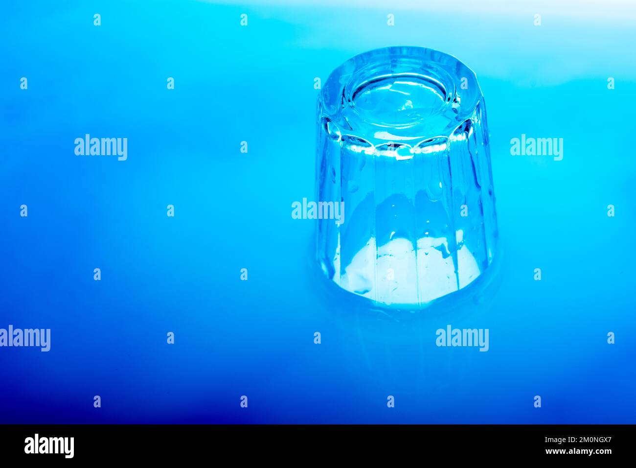 Blue color glass is placed in blue color water Stock Photo - Alamy