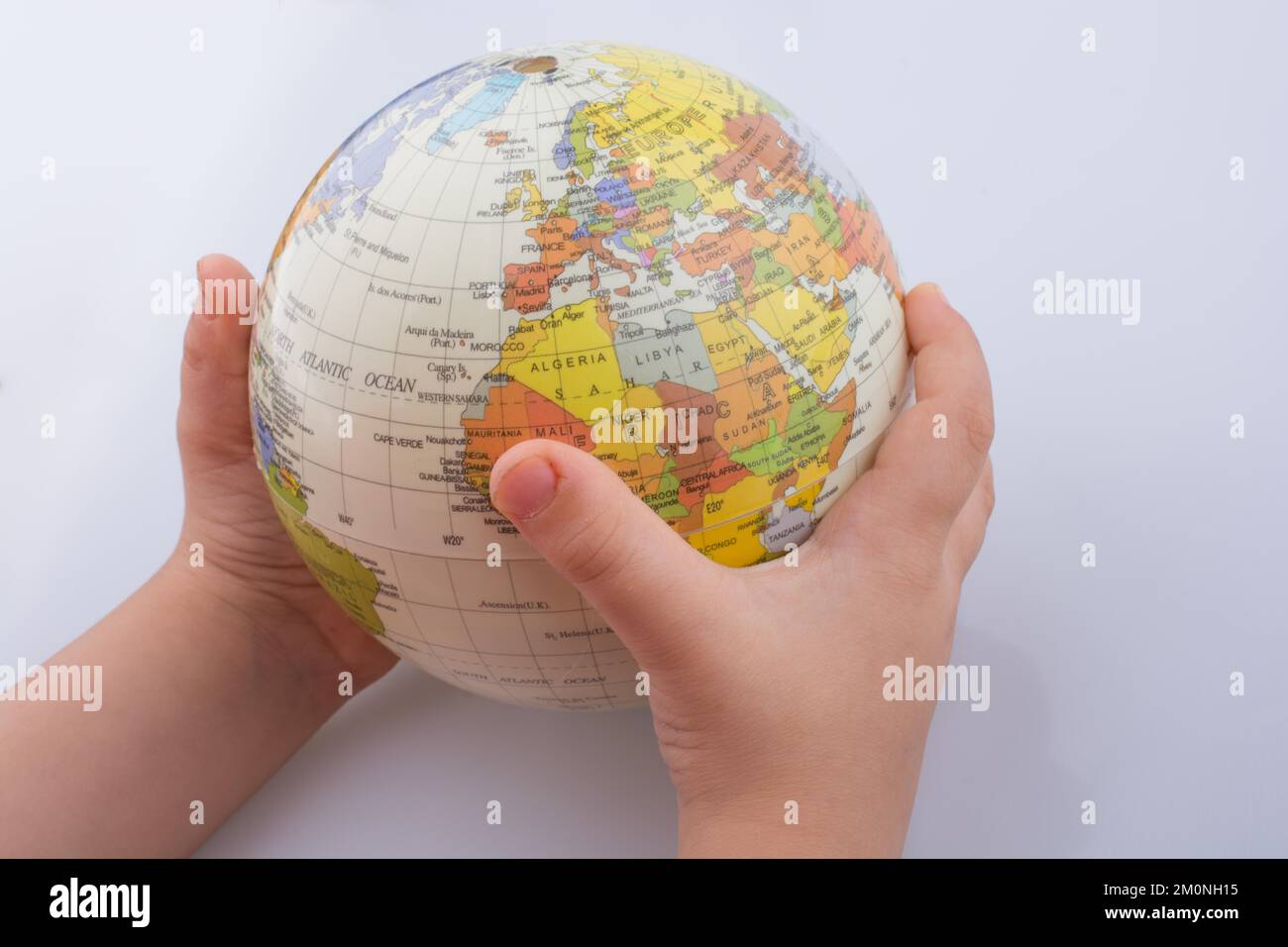 Child holding a globe in his hand on a white background Stock Photo - Alamy