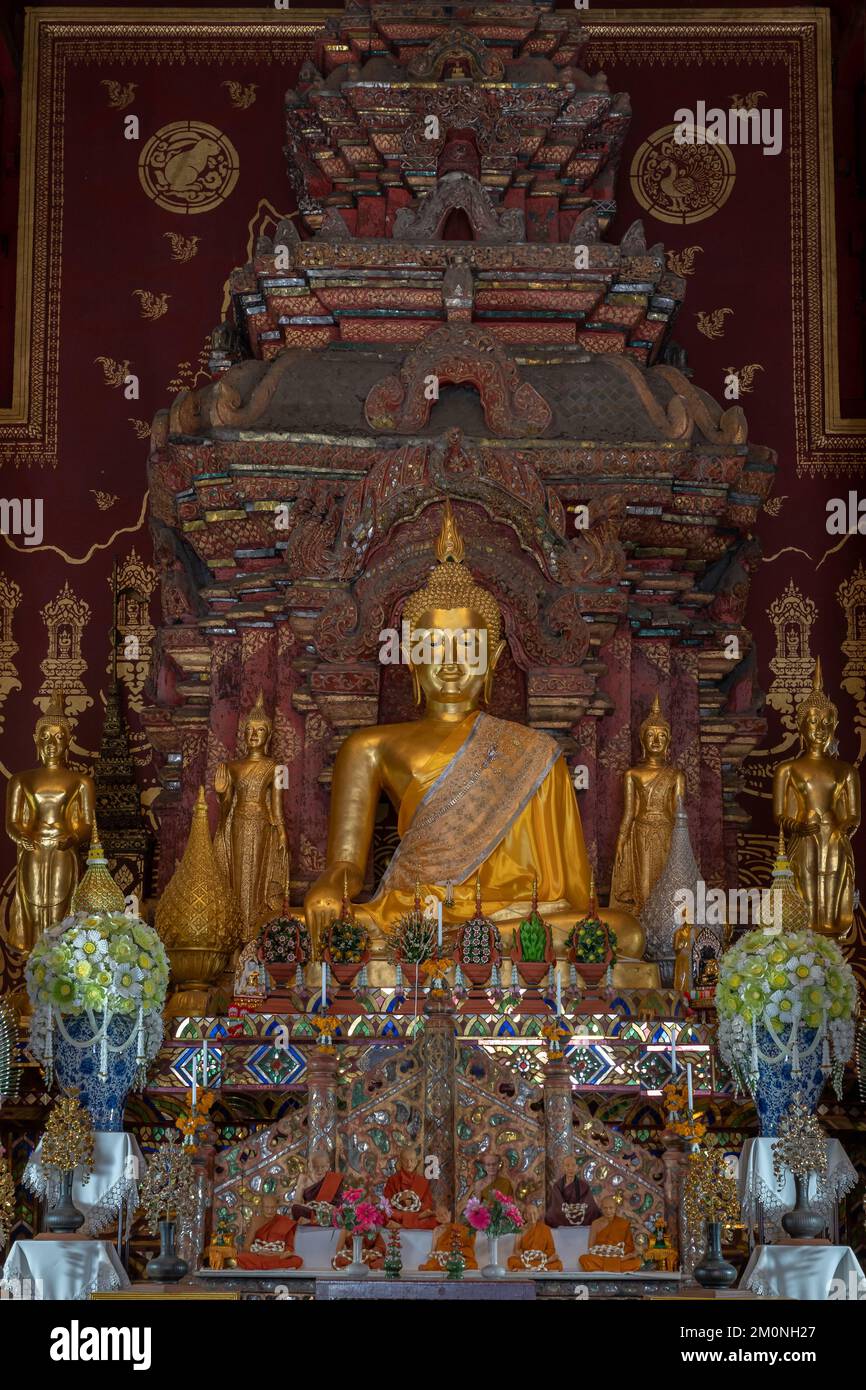 Ancient golden Buddha statues with traditional Lanna style decor inside ...