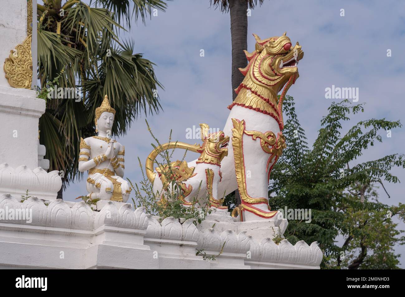 White and gold lion or singha guardian protector statue standing on ...