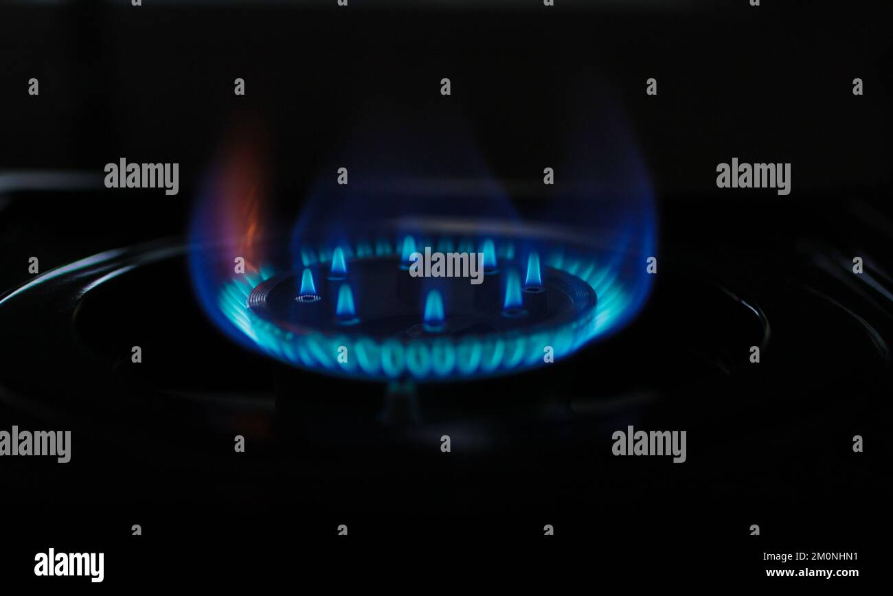 Natural gas blue fire flame on kitchen burner gas stove on dark ...
