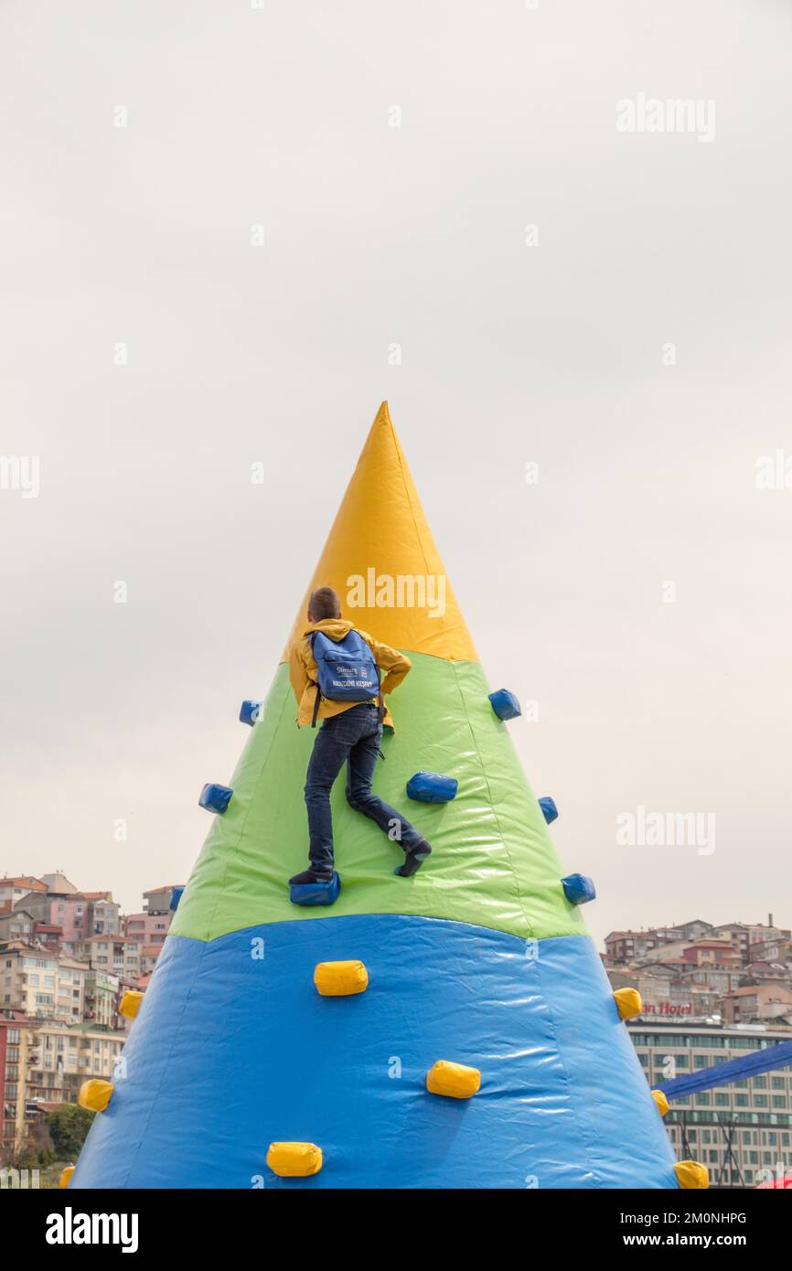A boy climbing on cone shaped climbing course Stock Photo - Alamy