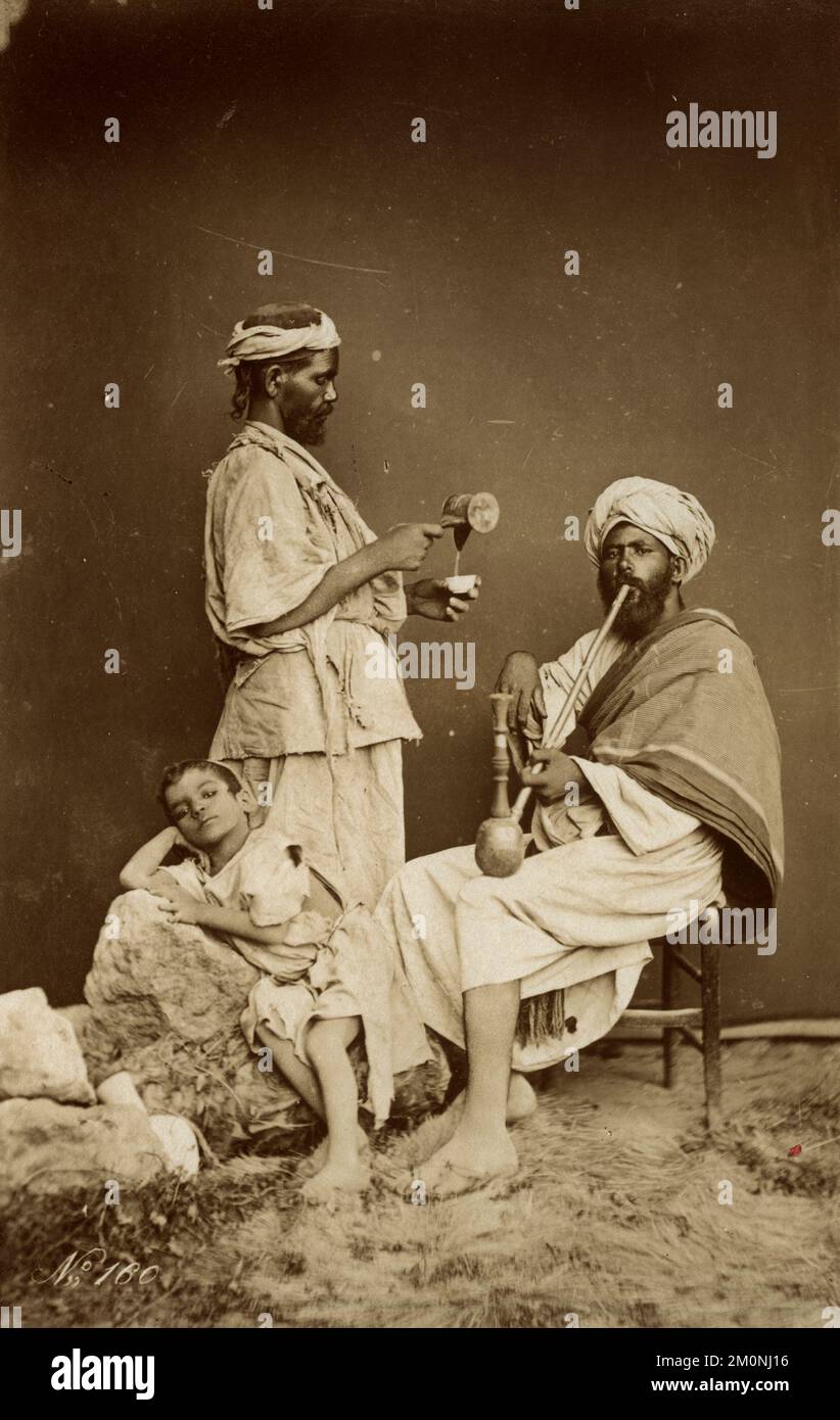 Portrait of a coffee merchant serving a man smoking a pipe, circa 1870 ...