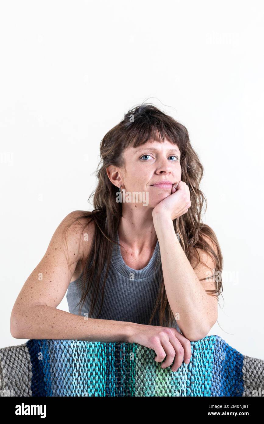 Beautiful woman looking at camera over a white background. Studio Shot ...