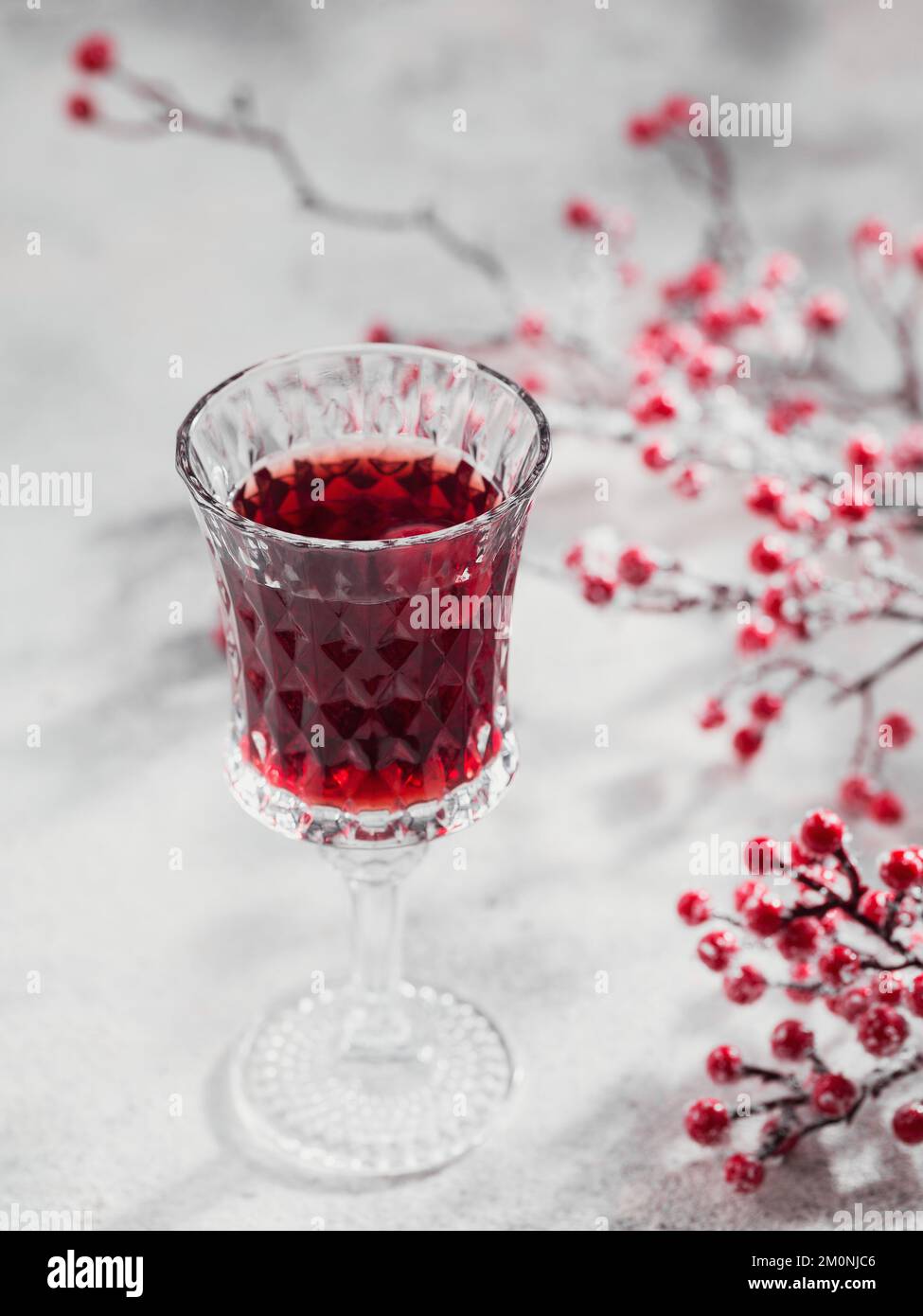 Glass of cherry liqueur on white background Stock Photo - Alamy