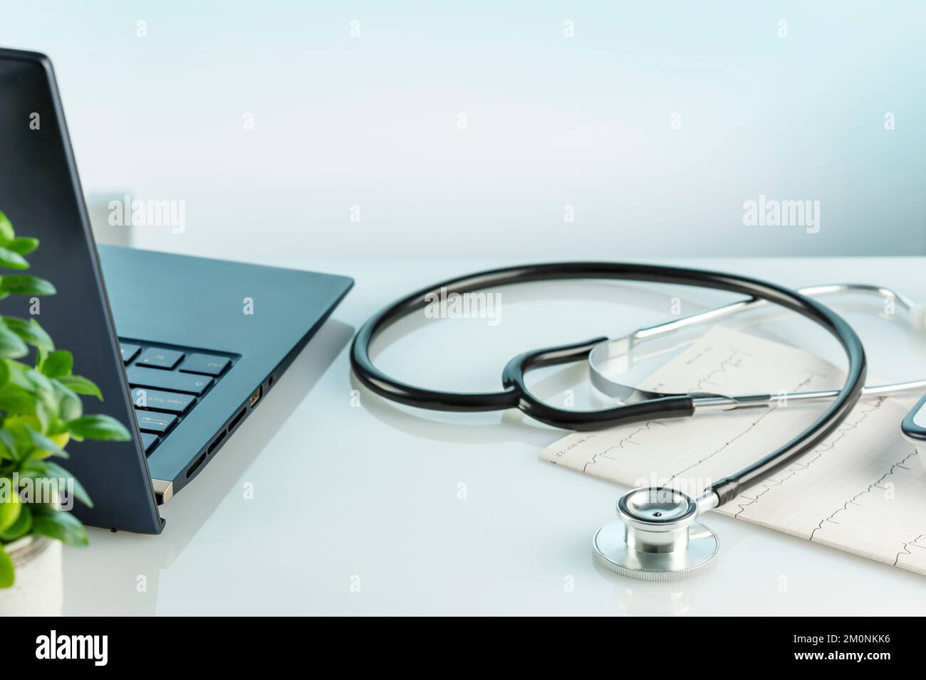 Doctor's office desk with laptop, medical documents, cardiogram ...