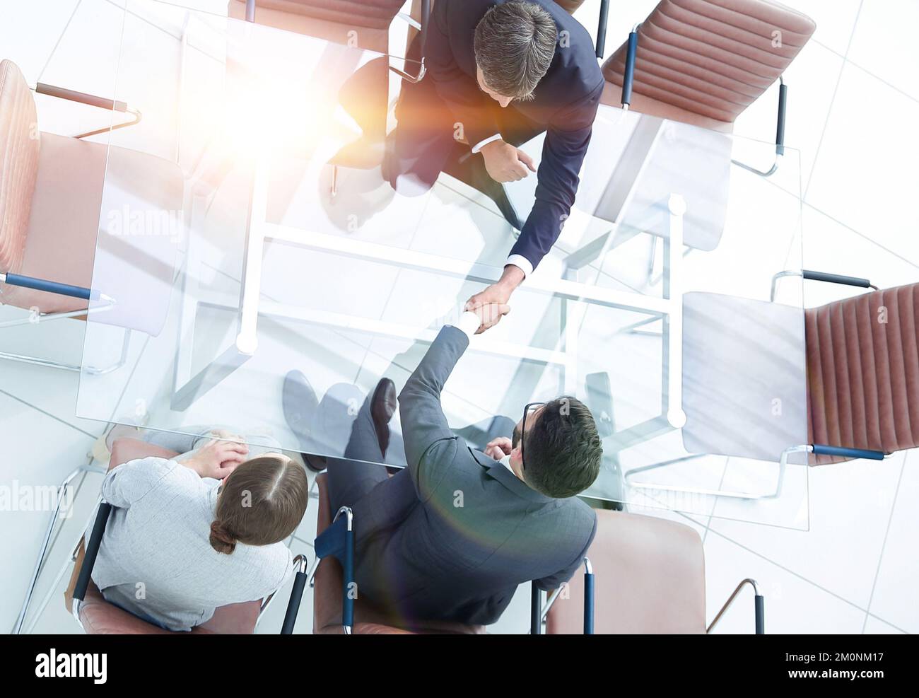 Handshake across table hi-res stock photography and images - Alamy