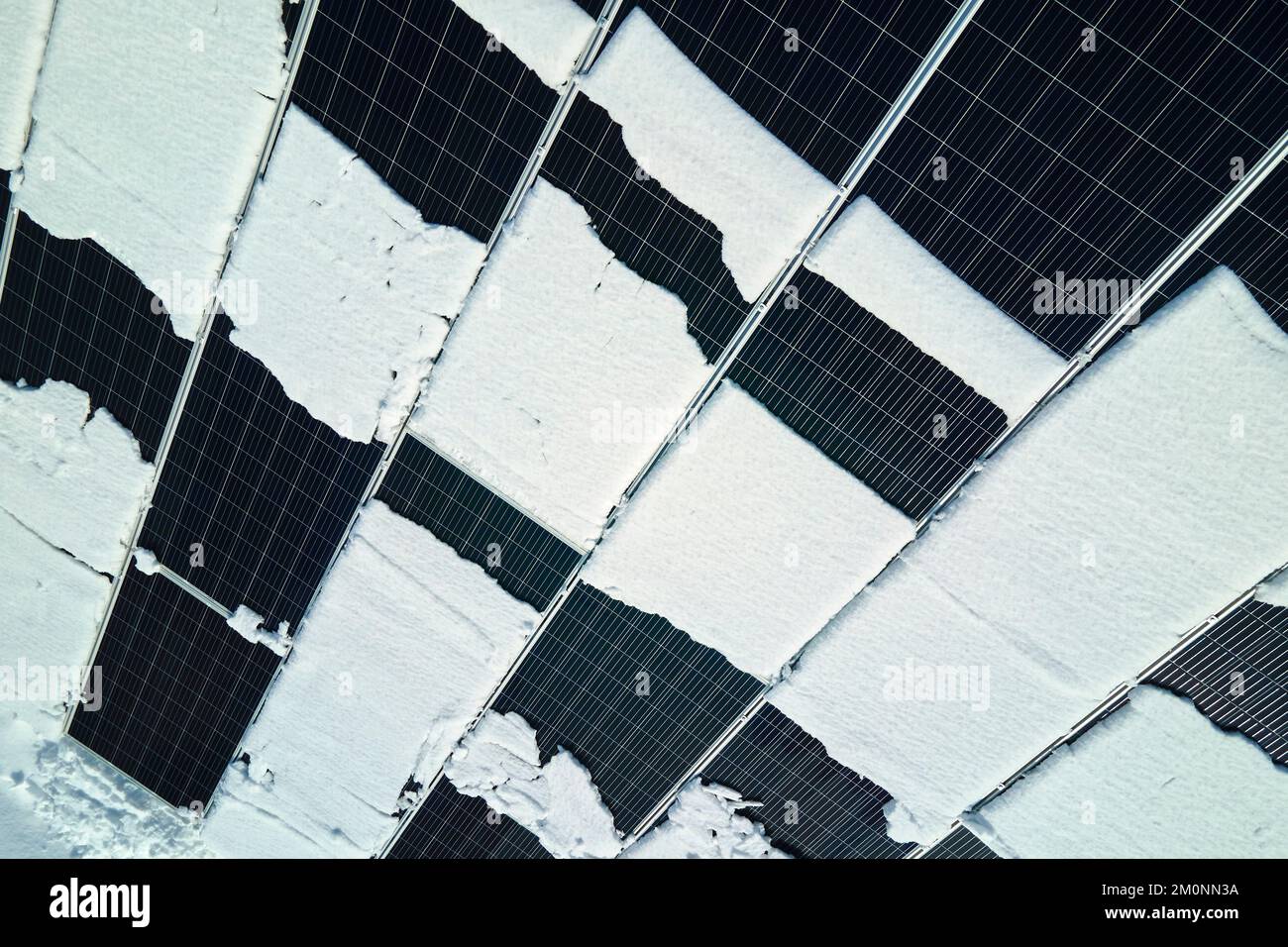 Aerial view of snow melting from covered solar photovoltaic panels at ...