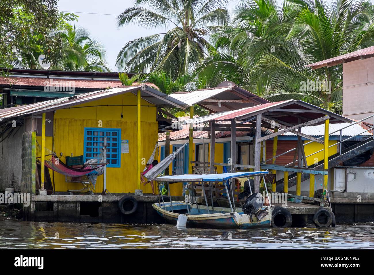 Houses and jetty on the shores of the Tortuguero Canal in Costa Rica ...