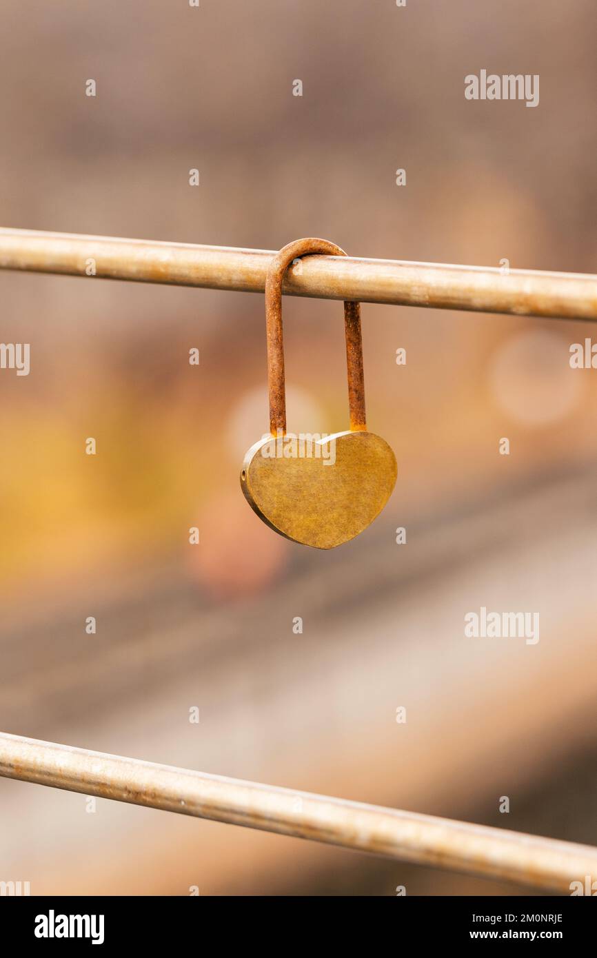 Heart shaped love lock hanging on bridge in autumn. Concept of love and ...