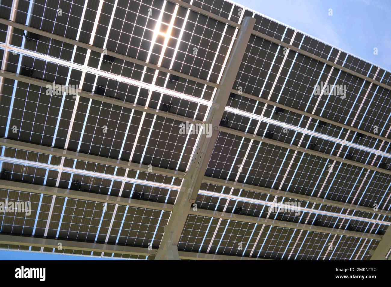 Solar panels installed over parking lot canopy shade for parked cars ...