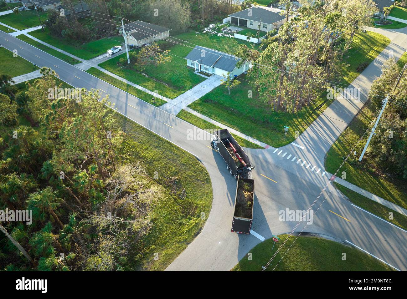 Special aftermath recovery dump truck picking up vegetation debris from ...