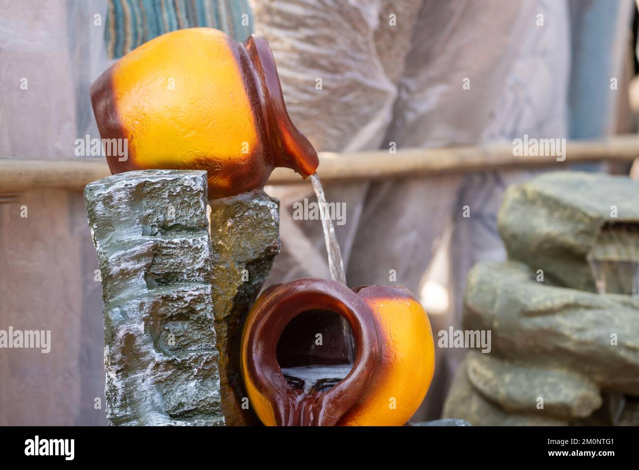 waterfall fountain with yellow pot pouring water placed in banjara ...