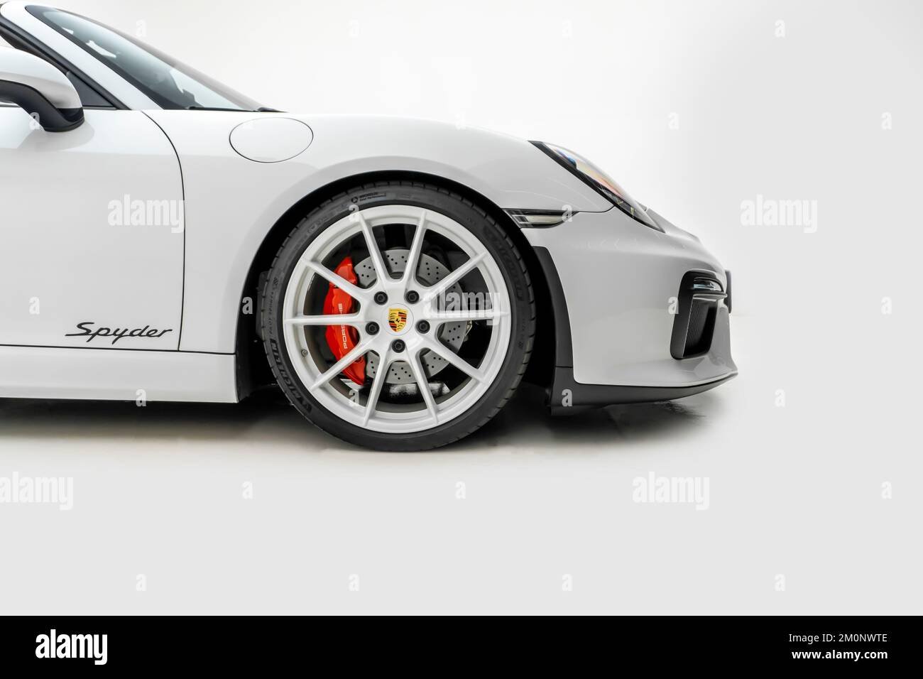 The side view of a white Porsche Boxster Spyder front wheel Stock Photo ...
