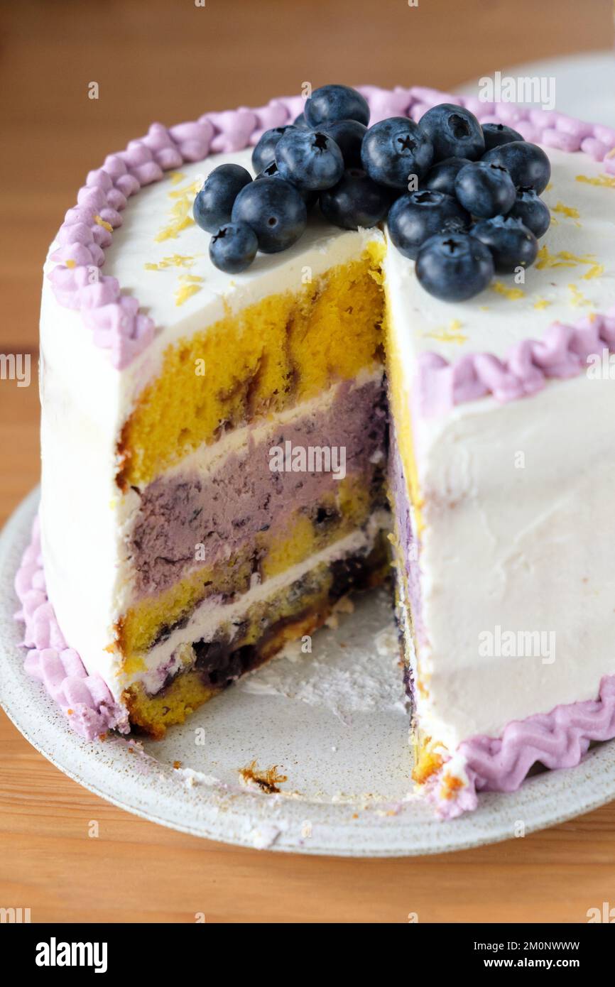 Blueberry lemon birthday or wedding cake with a slice cut out Stock ...