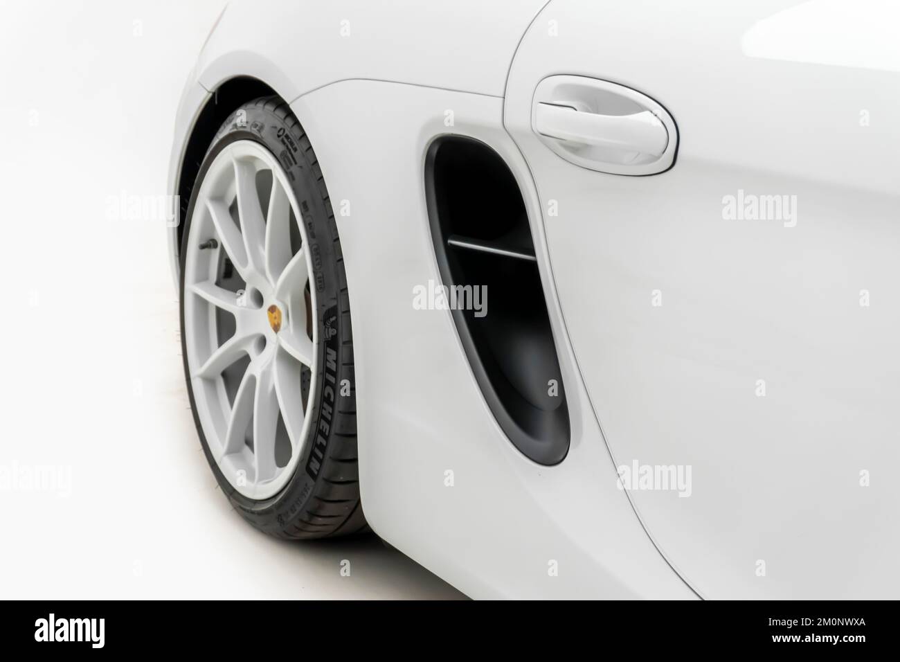 The side view of a white Porsche Boxster Spyder back wheel Stock Photo ...
