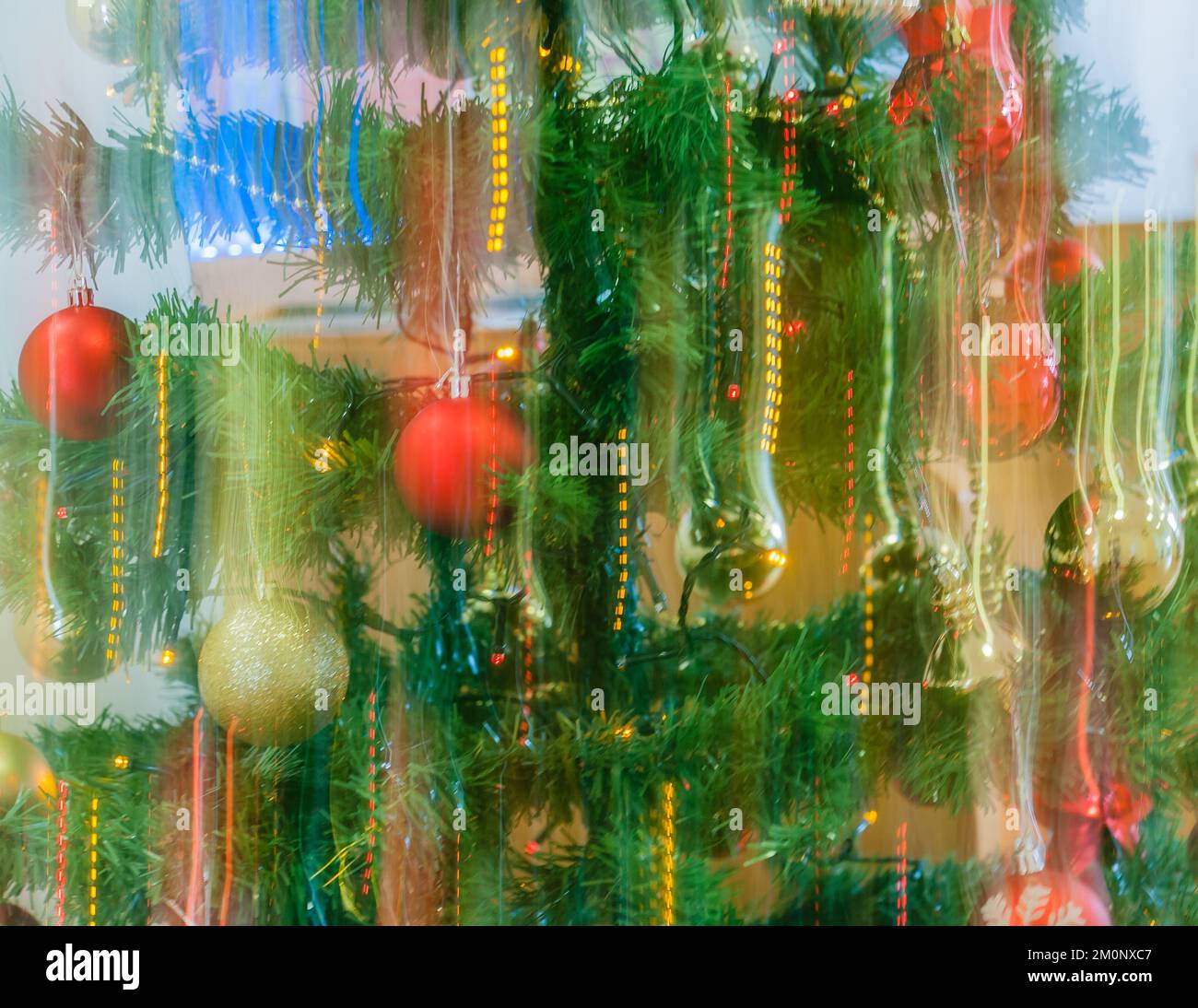 Photograph of shiny christmas tree objects illuminated by dynamic ...
