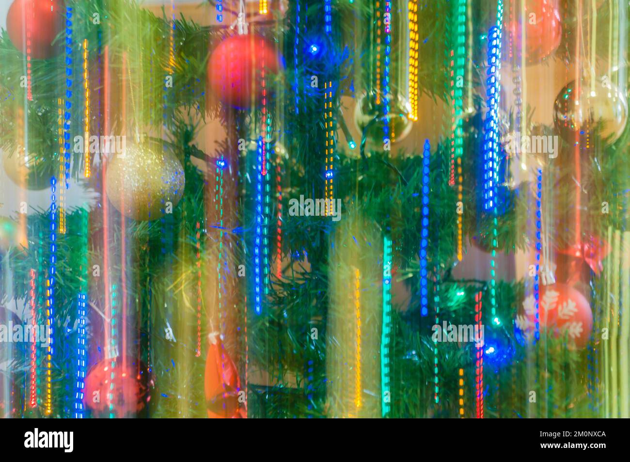 Photograph of shiny christmas tree objects illuminated by dynamic ...