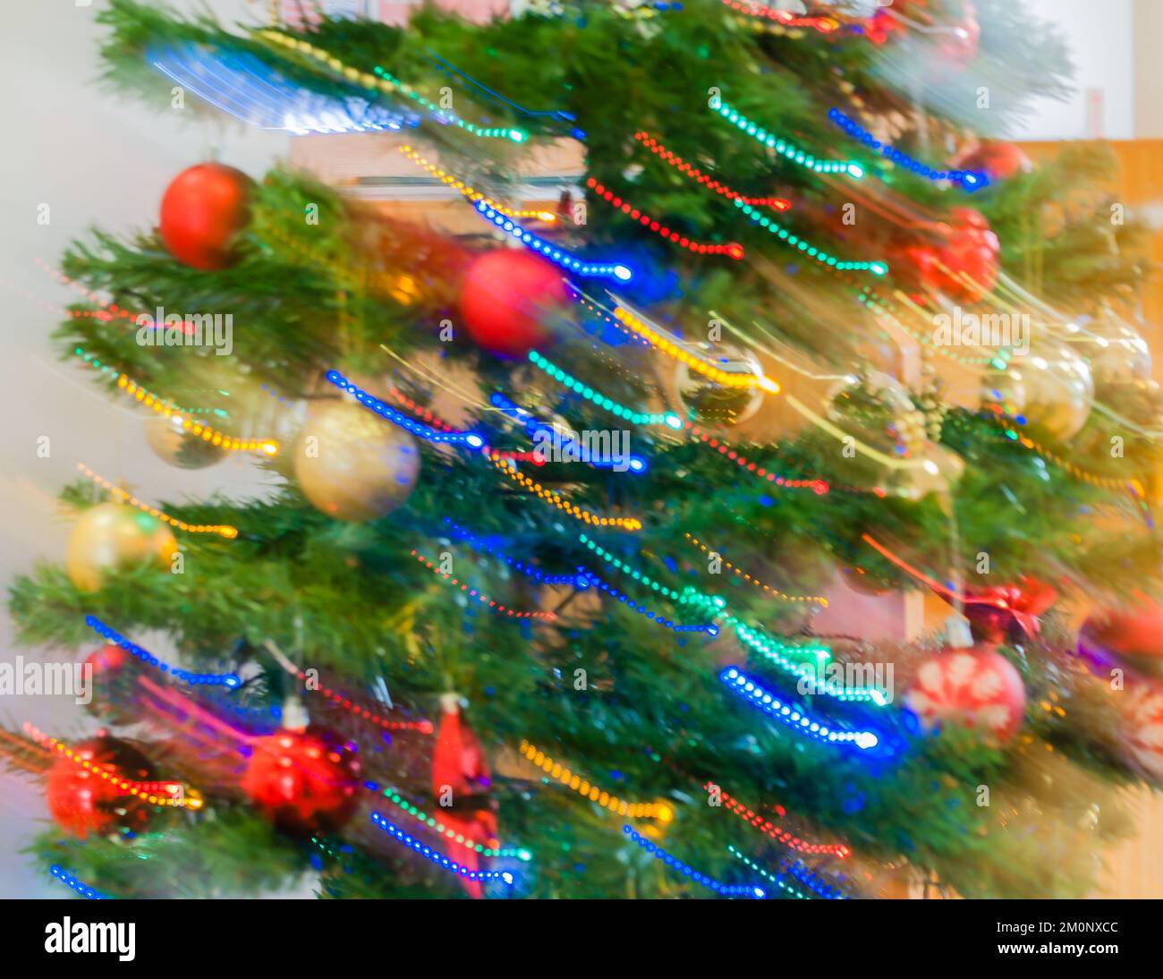 Photograph of shiny christmas tree objects illuminated by dynamic ...
