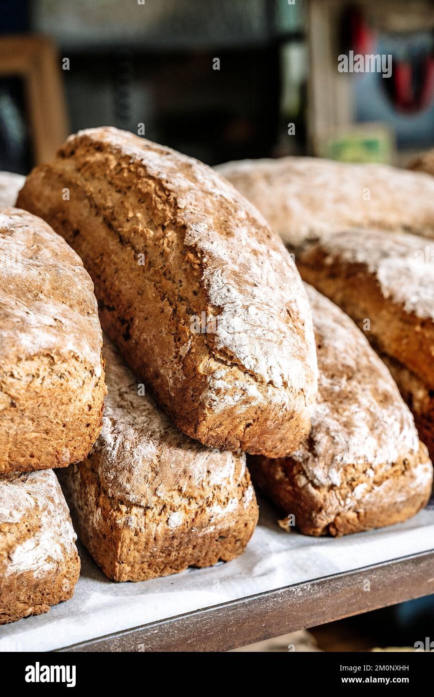 Loaves of bread on the shelves of the shop bakery counter. Fresh ...