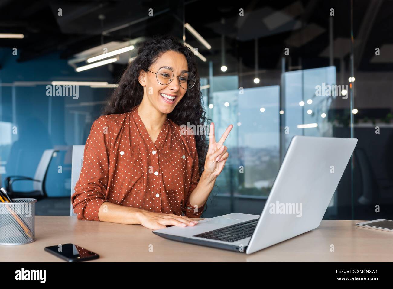 Cheerful And Successful Latin American Businesswoman Talking Remotely Via Video Call With