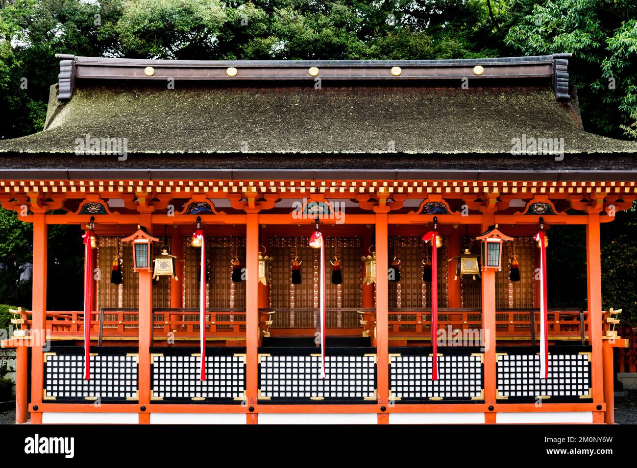 A traditional red Shinto temple in Kyoto Japan with columns during the ...