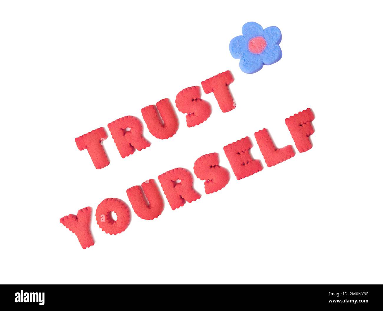 The word TRUST YOURSELF spelled with red alphabet cookies and blue ...