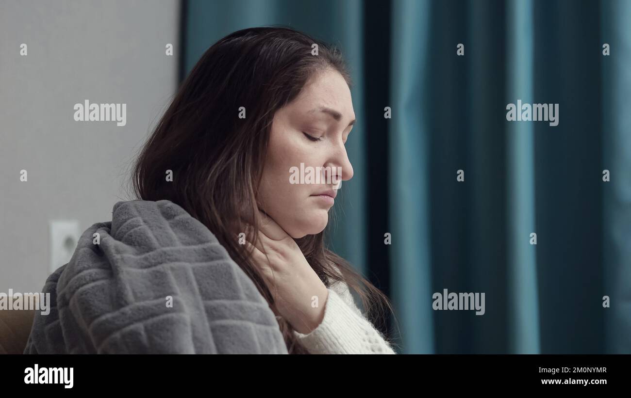 Adult woman covered with blanket feels unwell in cold house Stock Photo ...