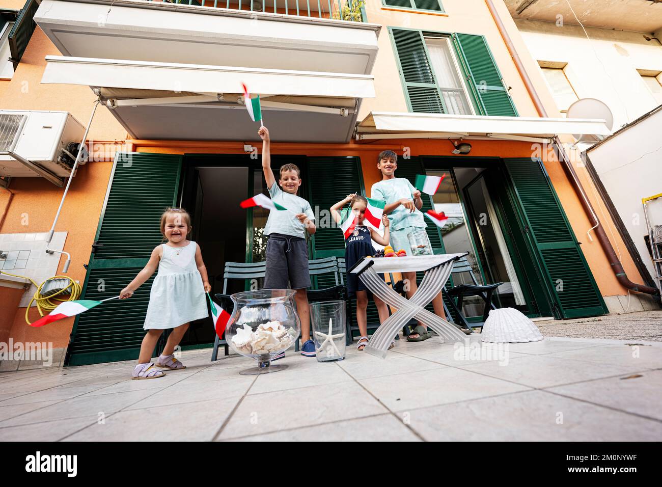 Happy four kids with italian flags celebrating Republic Day of Italy ...