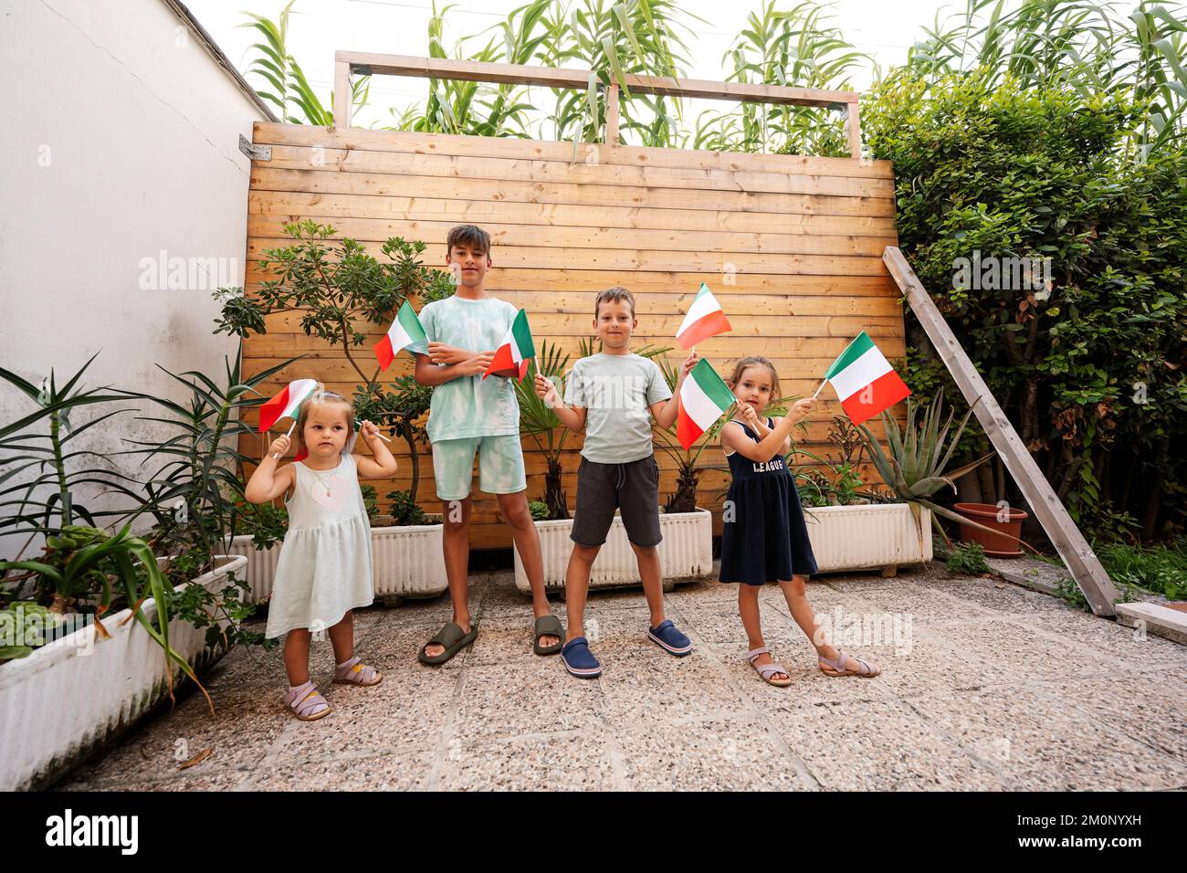 Happy four kids with italian flags celebrating Republic Day of Italy ...