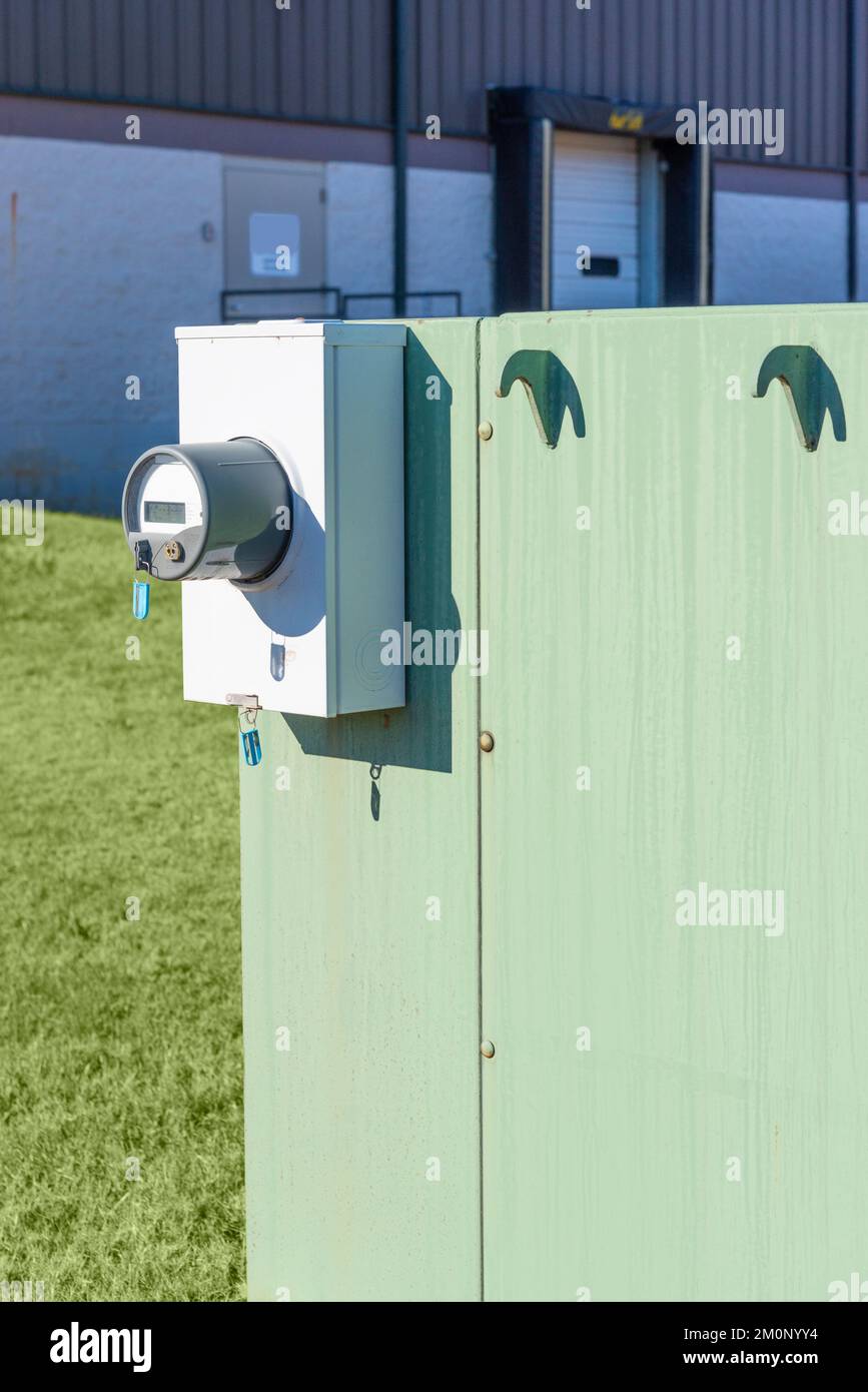 Vertical format image of close-up of electric meter behind commercial ...