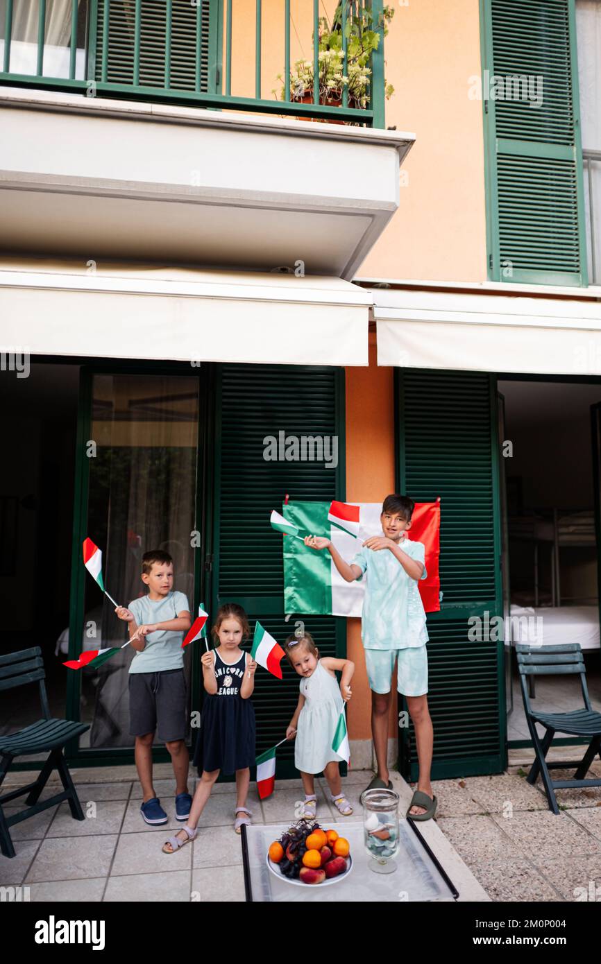 Happy four kids with italian flags celebrating Republic Day of Italy ...