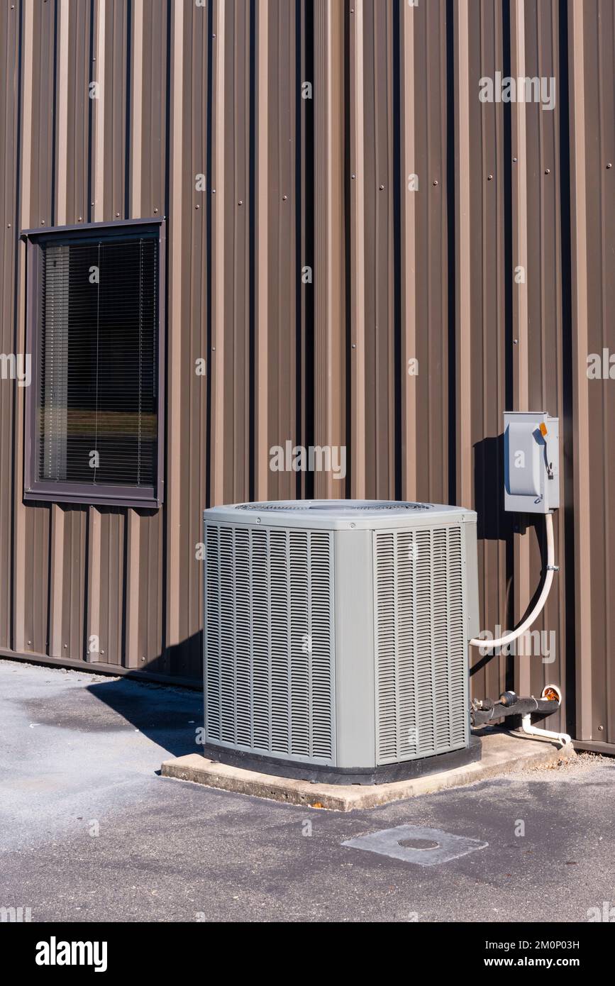 A vertical image showing an unlabeled air conditioning compressor ...