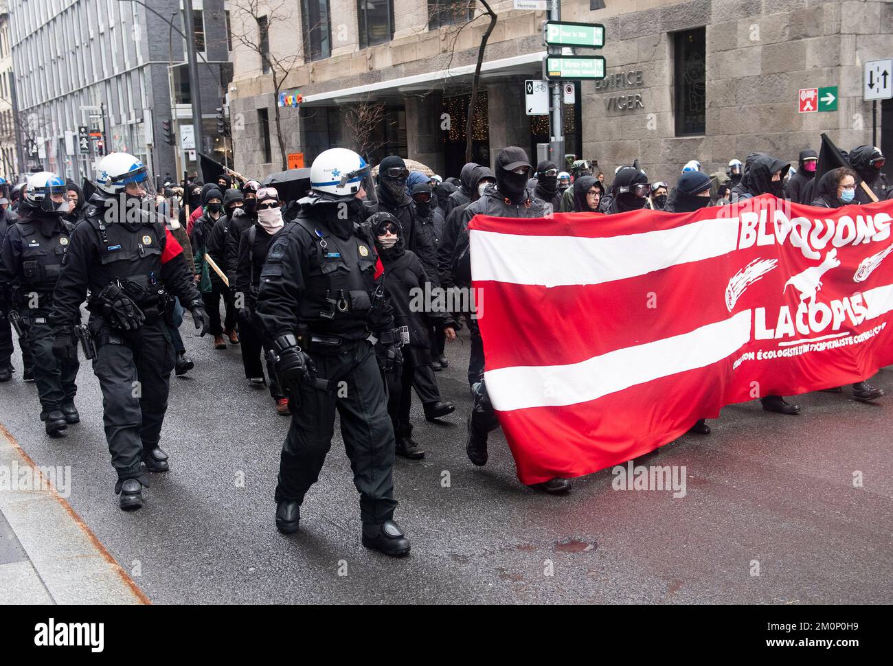 Montreal Canada, December 7, 2022. Riot police walk alongside ...