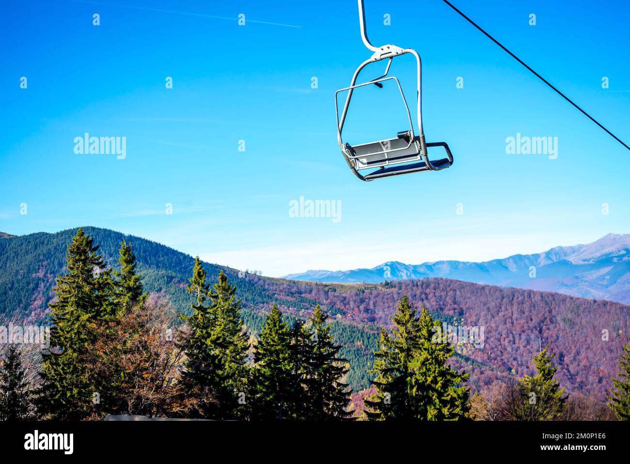 A beautiful view of the resort with cable car on a colorful wooded ...