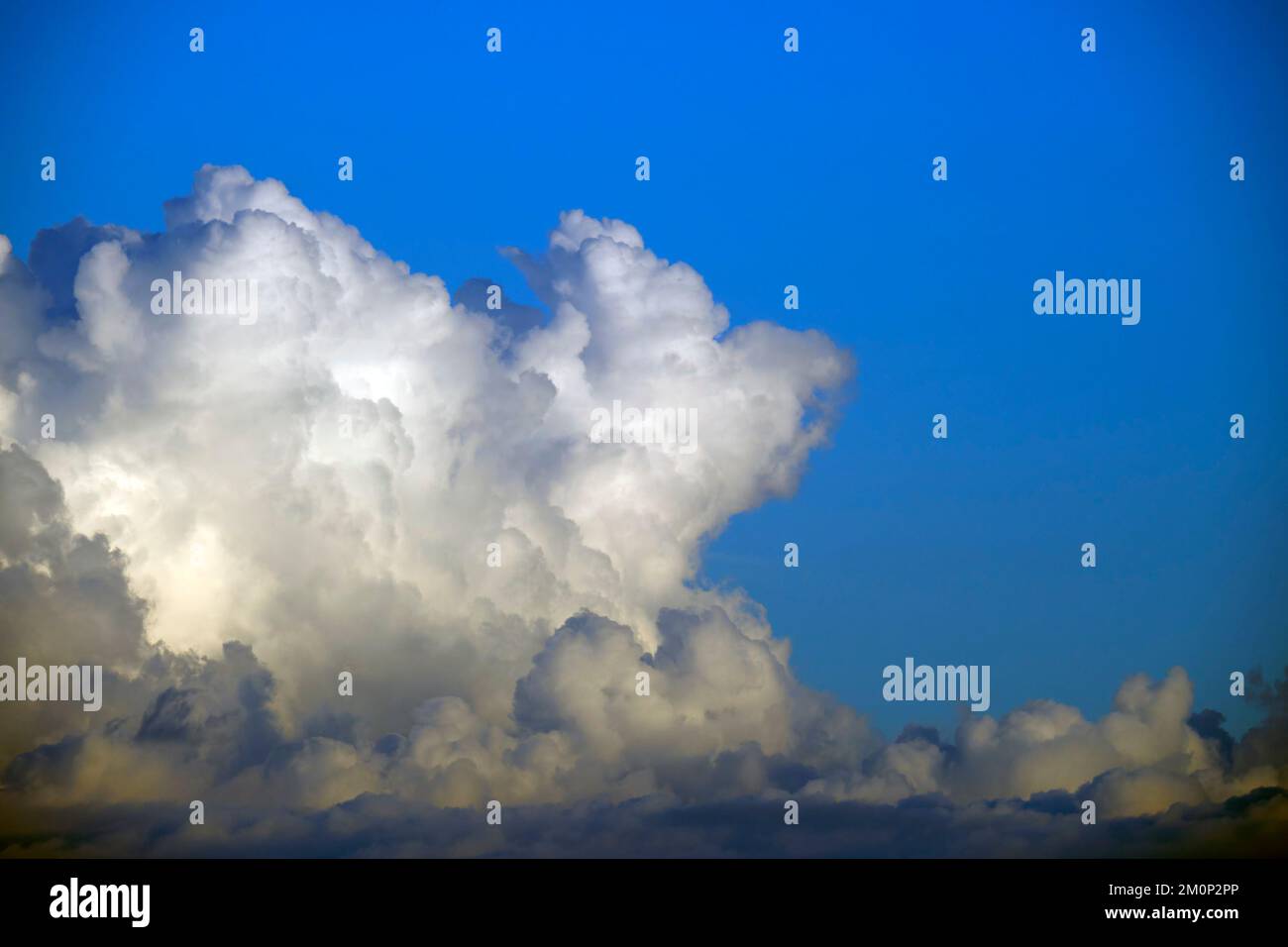 White fluffy cumulonimbus clouds forming before thunderstorm on summer ...