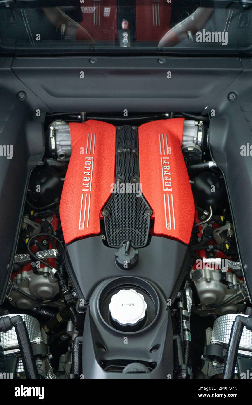 A vertical shot of a Ferrari 488 GTB Engine bay with red engine cover ...