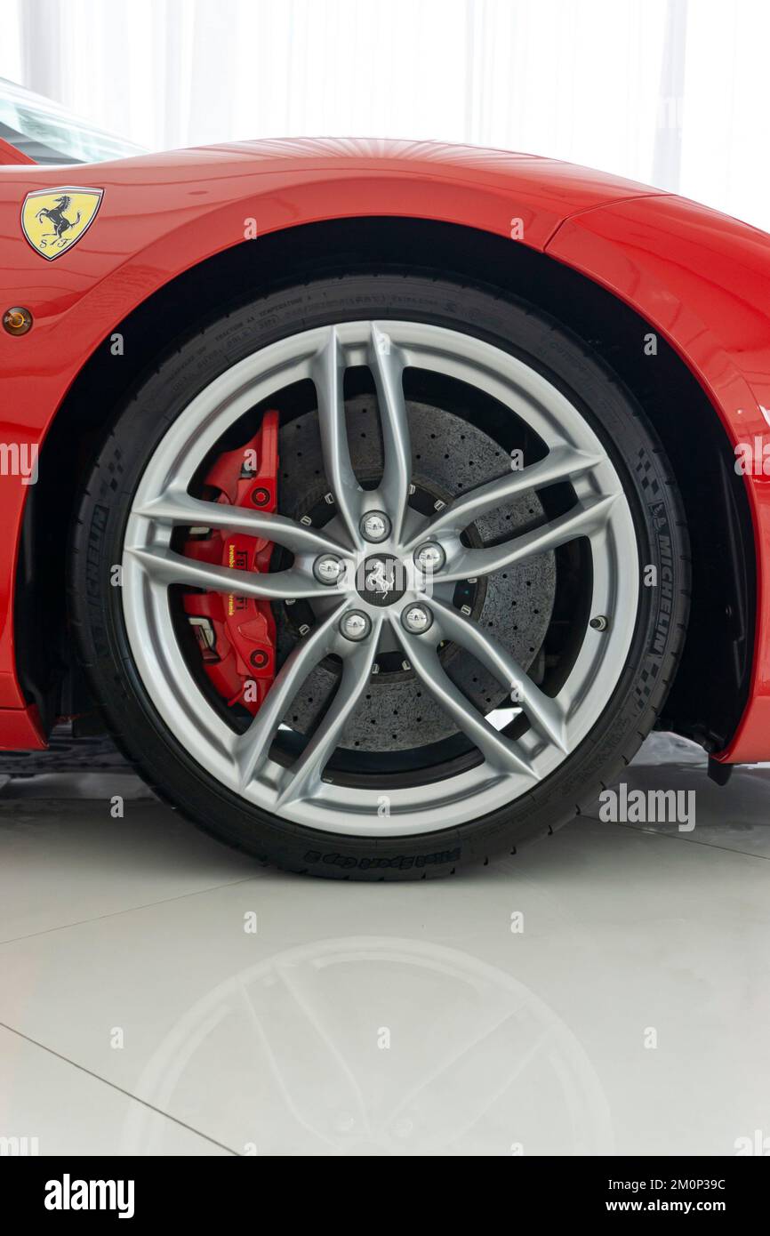 A vertical shot of a Ferrari 488 GTB Rosso Corsa with a silver wheel ...