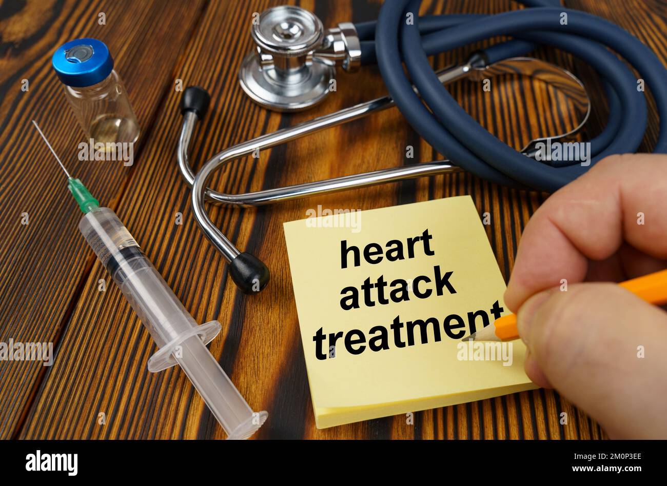 Medical concept. On the table is a stethoscope, a syringe, a man's hand ...