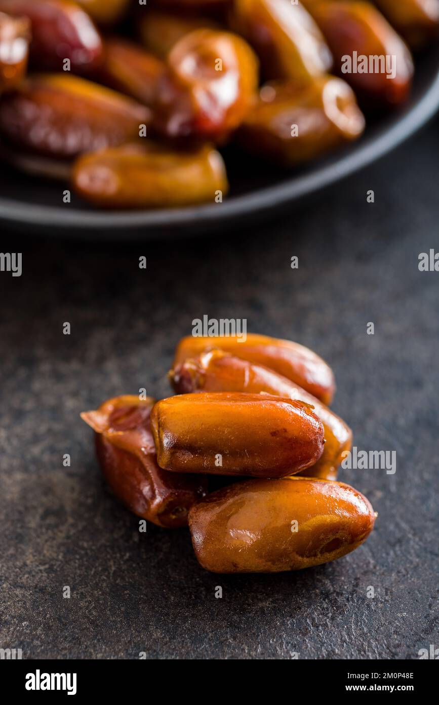 Dried dates fruit on the black table Stock Photo - Alamy