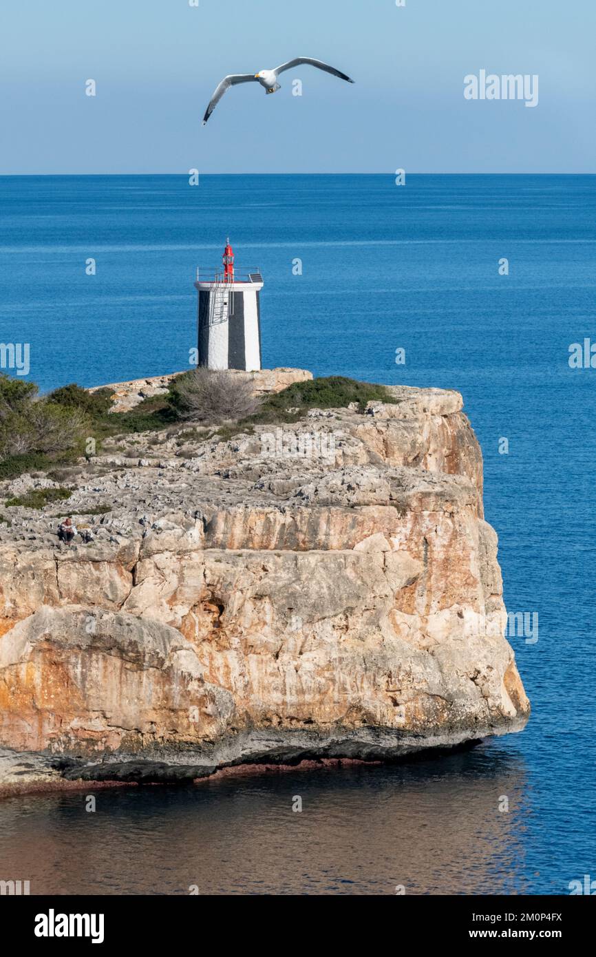 The lighthouse on the Morro de Sa Carabassa at the entrance to the bay ...