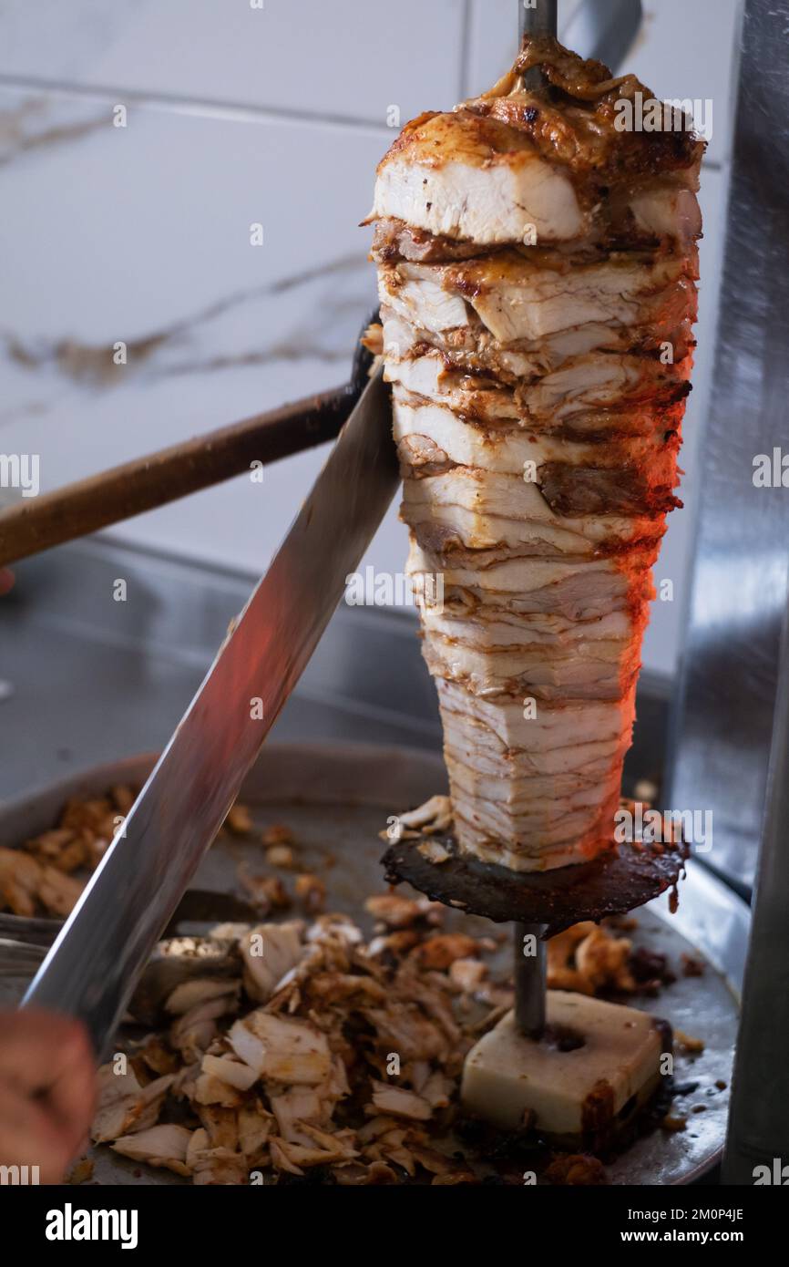Shawarma. Closeup picture of stacked meat roasting, shawarma. Food in ...