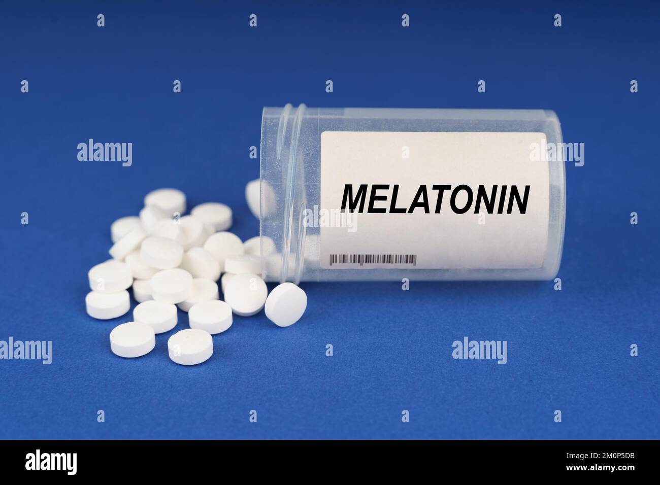 The concept of pharmacology and health. On a blue surface are pills and ...