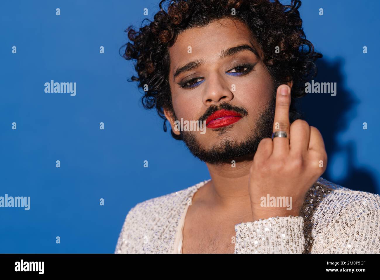 Young excited man with makeup showing his ring at camera isolated over ...