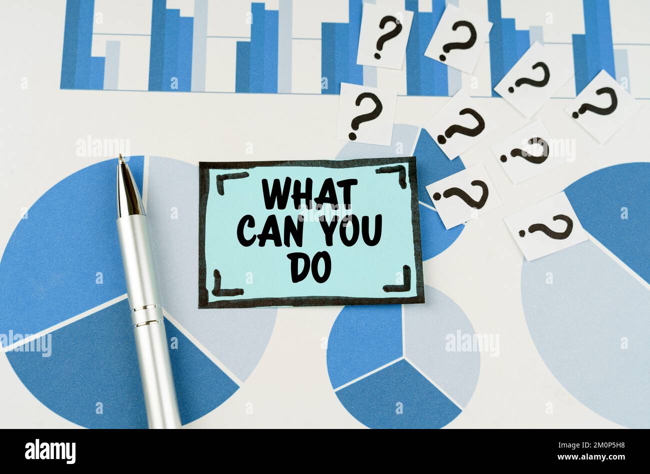 business question concept. On the blue diagrams lies a pen, questions ...