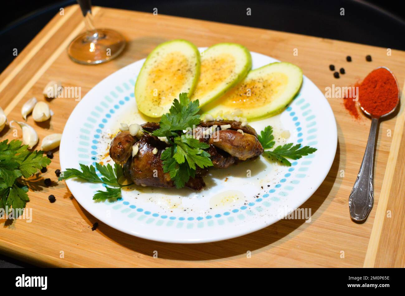 A chicken liver with slices of zucchini on the plate Stock Photo - Alamy